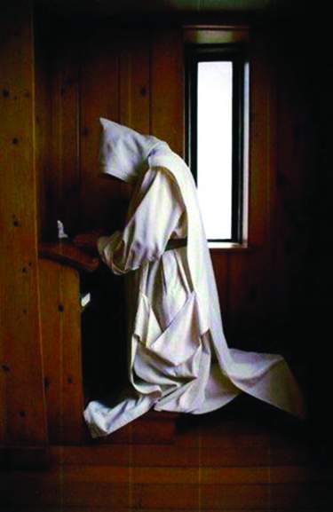 Solve Carthusian monk in prayer stall jigsaw puzzle online with 40 pieces