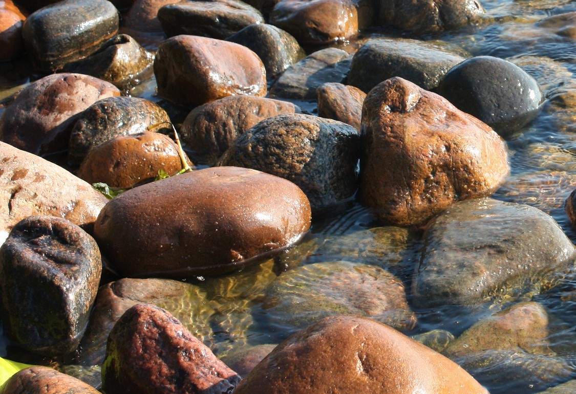 Jigsaw Puzzle | Smooth rocks in a river. This is a close-up. Imagine ...