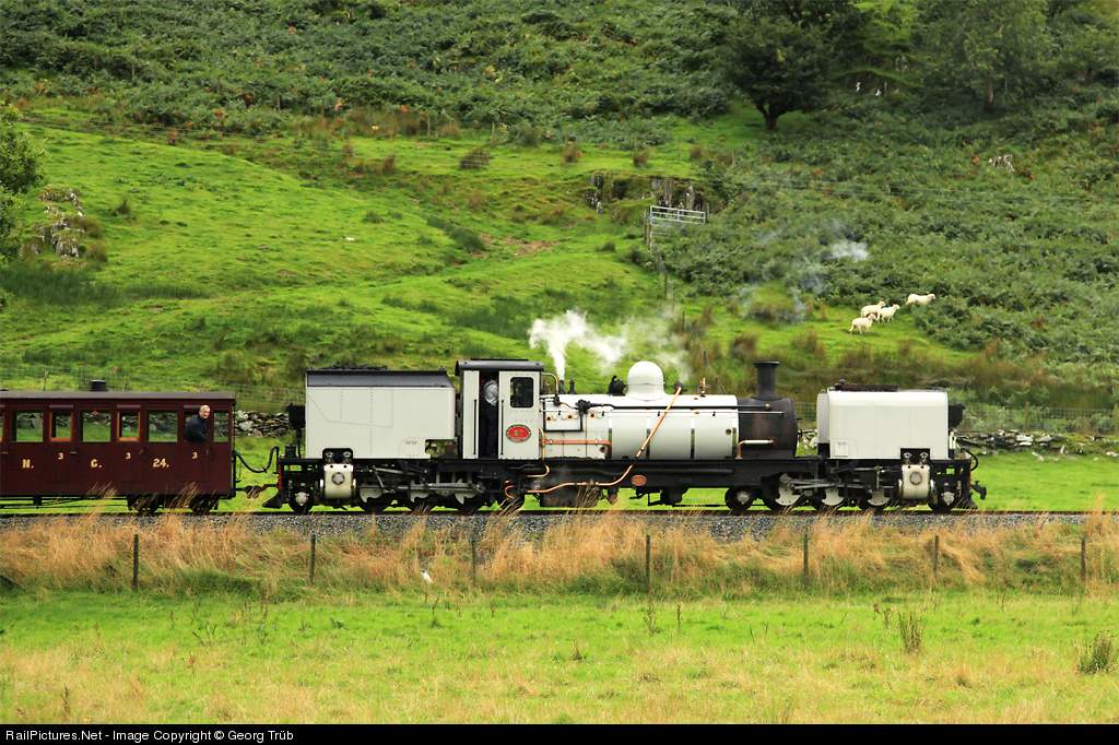 Solve The color of the Garratt locomotive almost disguises and hides the sheep on the hillside ...