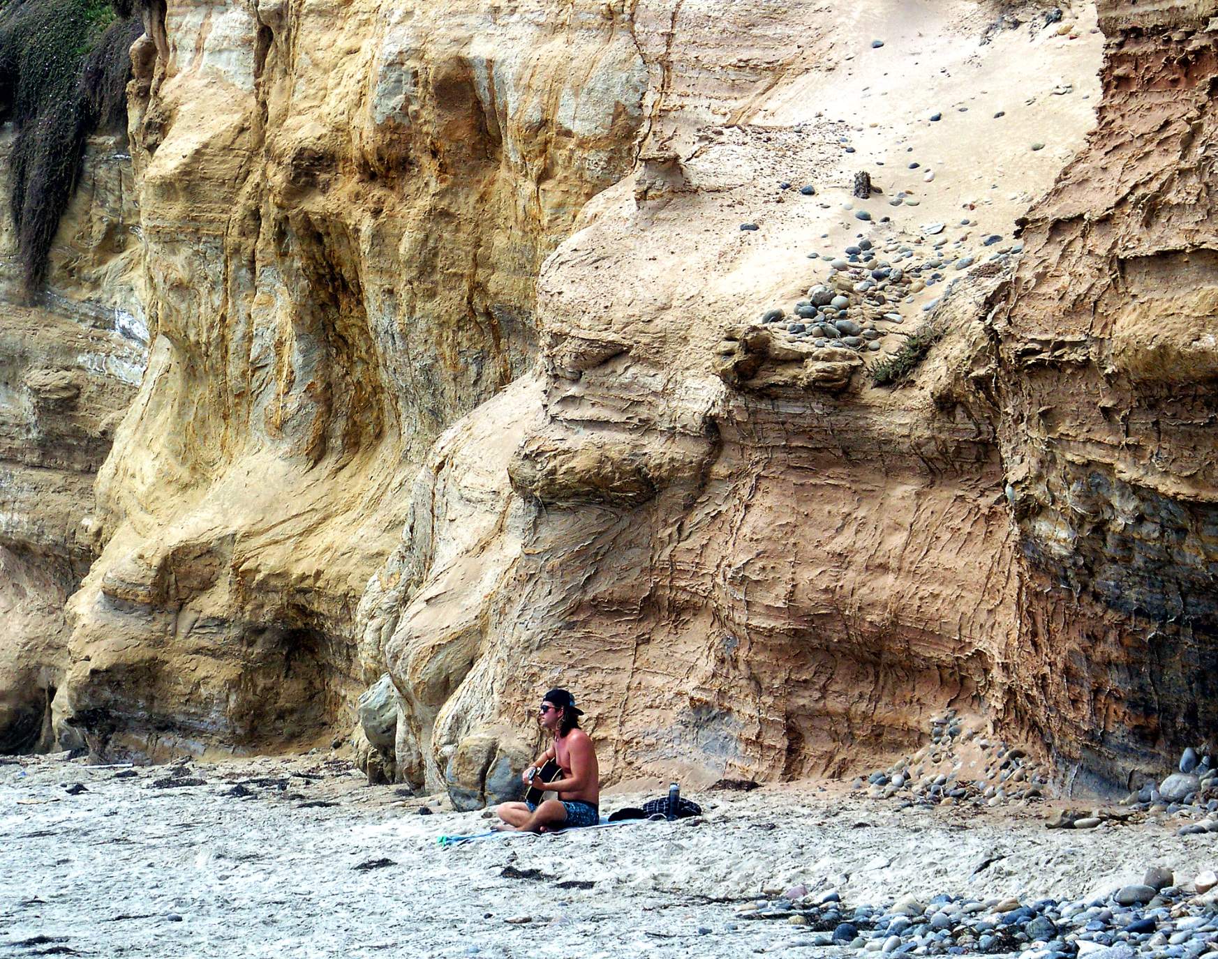 Solve Pacific Beach - Music Man Under Cliffs jigsaw puzzle online with ...