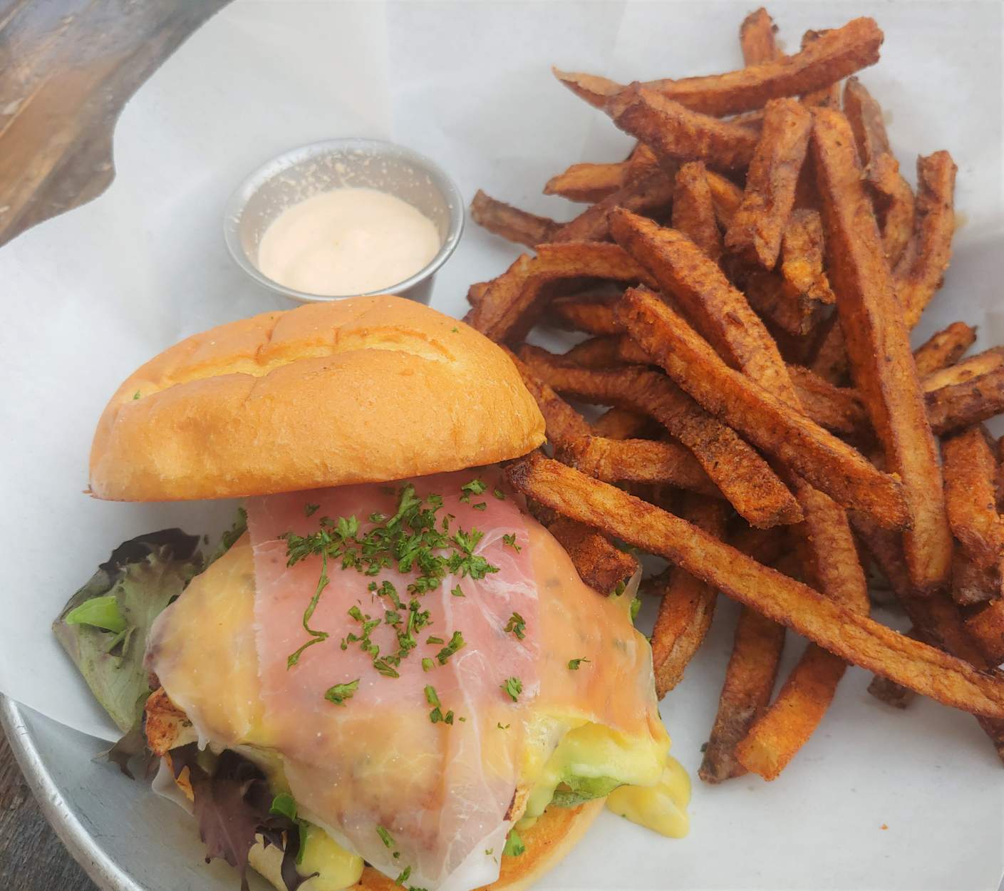 Solve Halibut sandwich with prosciutto and herb hollandaise and a side ...